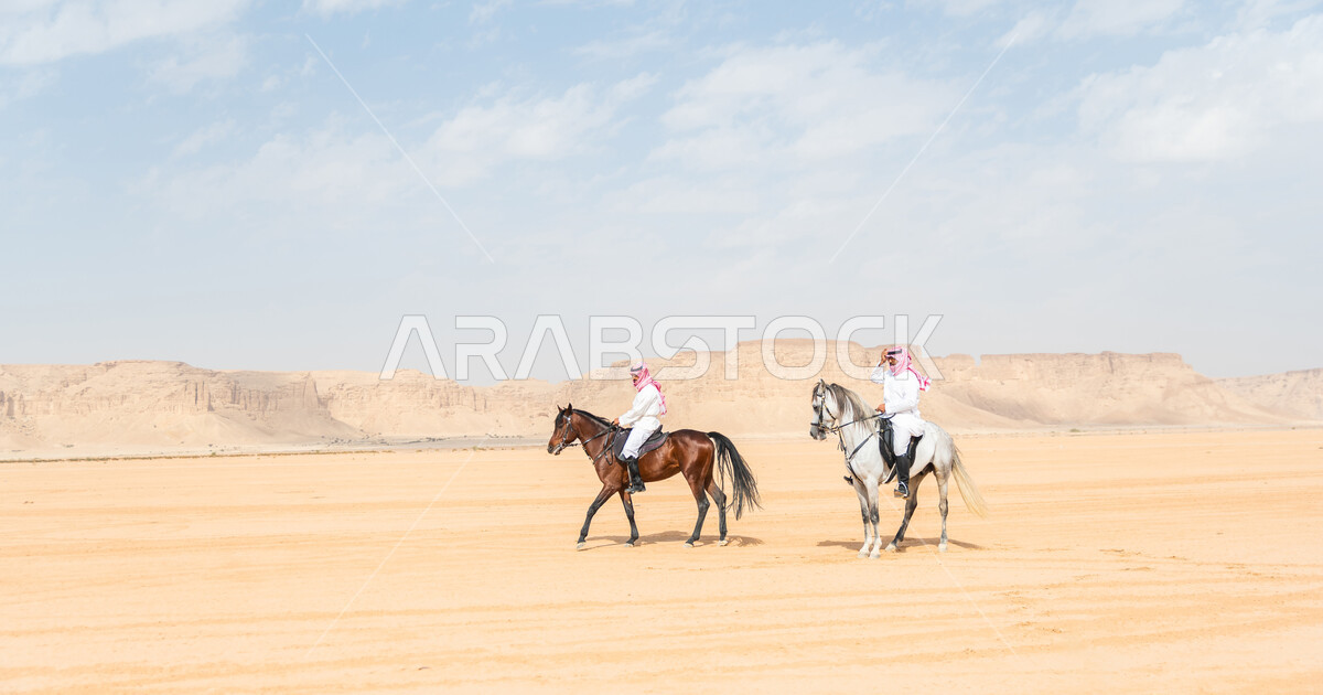 Two Saudi Arabian Gulf riders riding horses in the picturesque Saudi ...