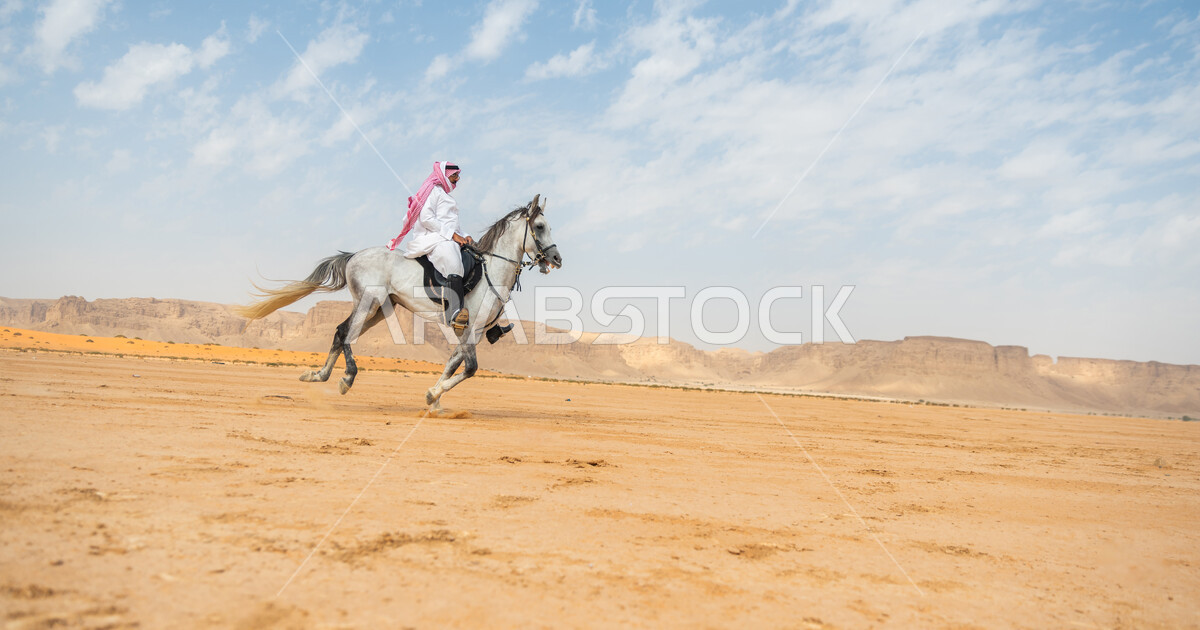 A Saudi Gulf rider riding horses at high speed in the picturesque Saudi ...
