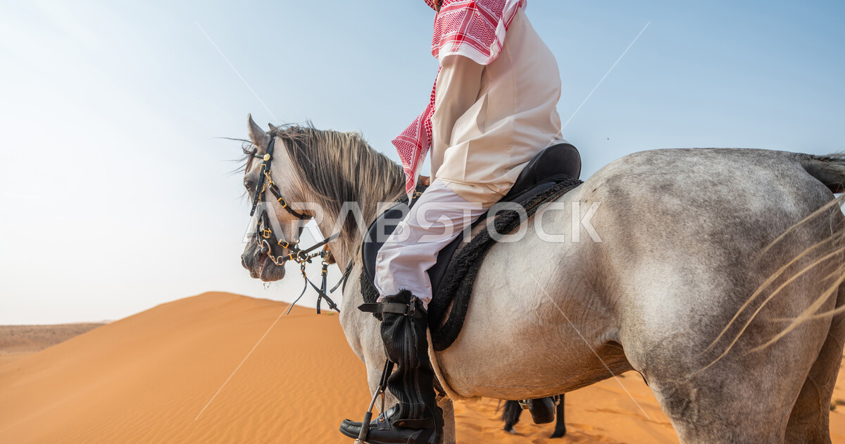 A close-up photo of a Saudi Gulf rider riding horses in the picturesque ...
