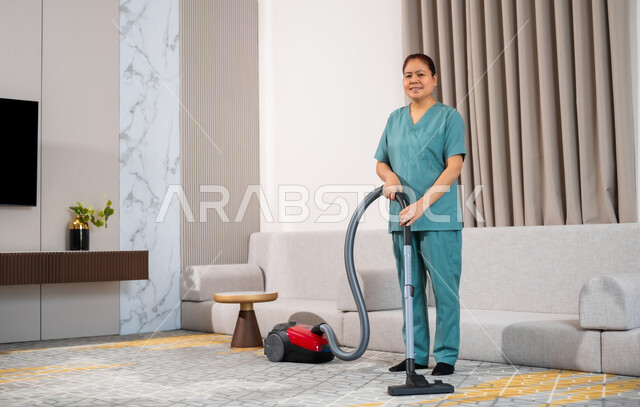 Quality of services in Saudi Arabia, a cleaning lady wearing her work ...