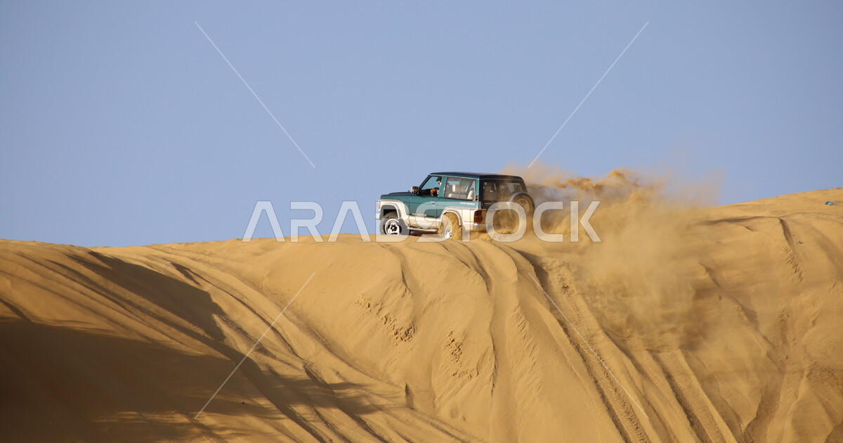 Car racing in Saudi Arabia, driving four-wheel drive vehicles in desert ...