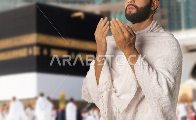 A Saudi Arabian Gulf Muslim man in the Ihram dress, raising the hands ...