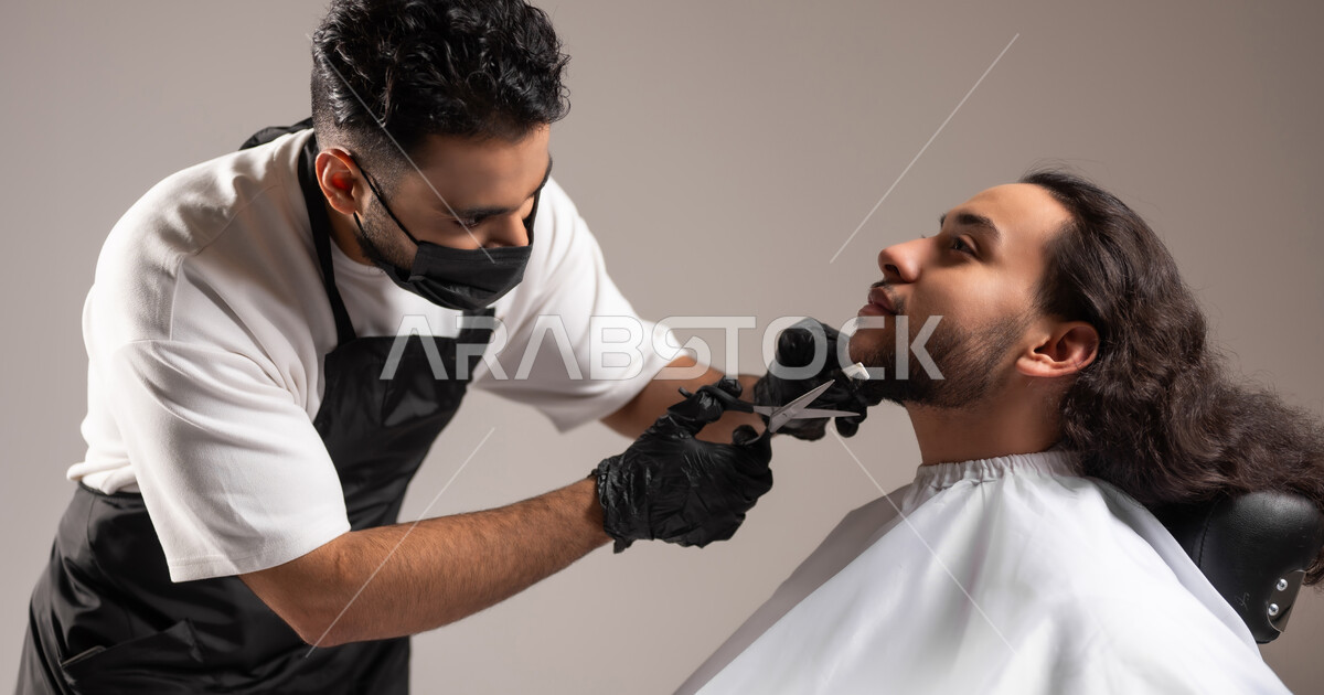 Providing personal care services, using scissors and a comb to shave ...