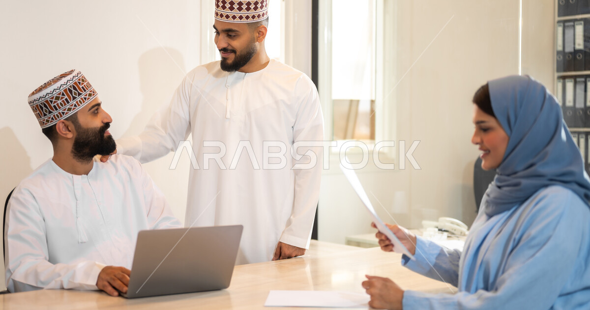 Comfortable environment in Omani companies, exchanging conversations ...