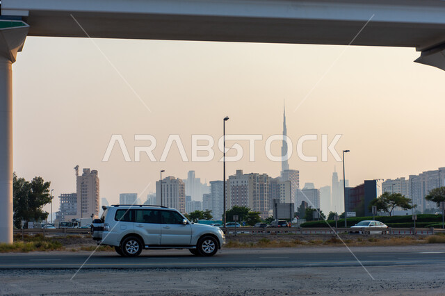 4WD vehicle driving under Dubai bridge, urban growth and development of ...