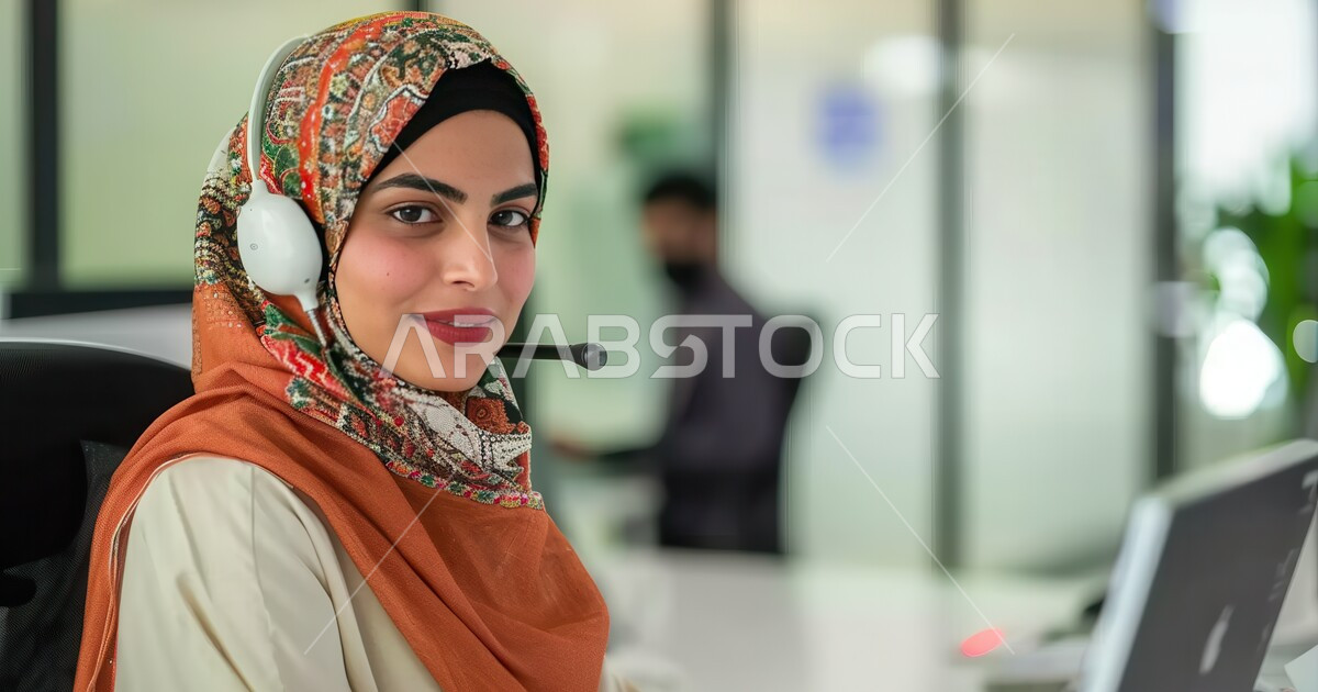 Sitting behind a desk and doing work on a computer, empowering women to ...