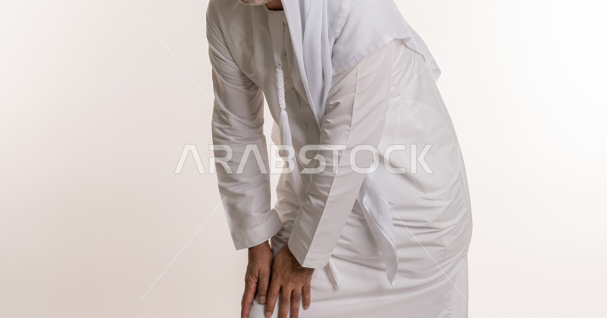 Feeling pain in the knee, portrait from the back of an elderly Arab ...