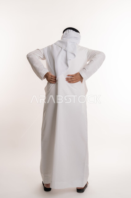 Feeling pain in the spine, portrait from the back of an elderly Arab ...