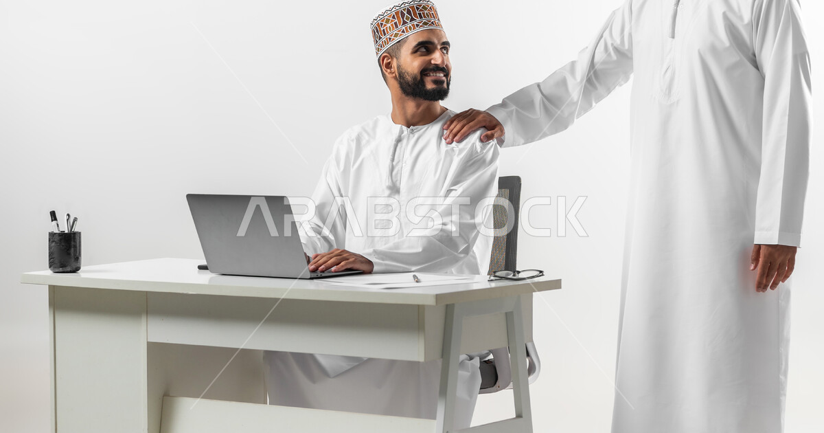 Work atmosphere and accomplishing tasks, portrait of two young Gulf ...