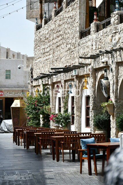 Outdoor seating and cafes, wooden tables and chairs inside the alleys ...