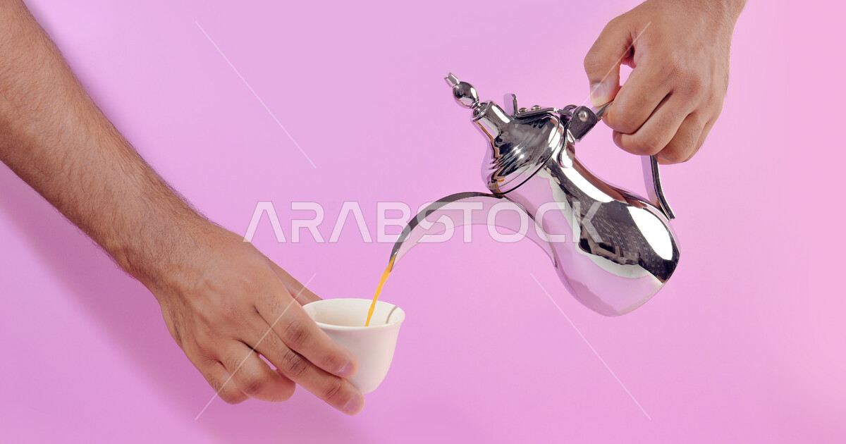 A silver dallah made of fine Arabic coffee, a portrait of a close ...