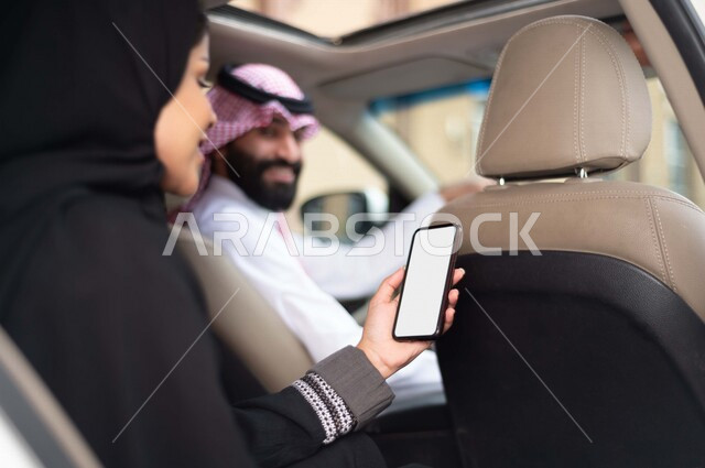 A Saudi Arabian Gulf driver driving the car, a veiled Saudi Arabian ...