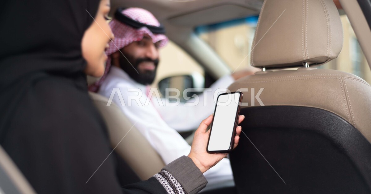 A Saudi Arabian Gulf driver driving the car, a veiled Saudi Arabian ...