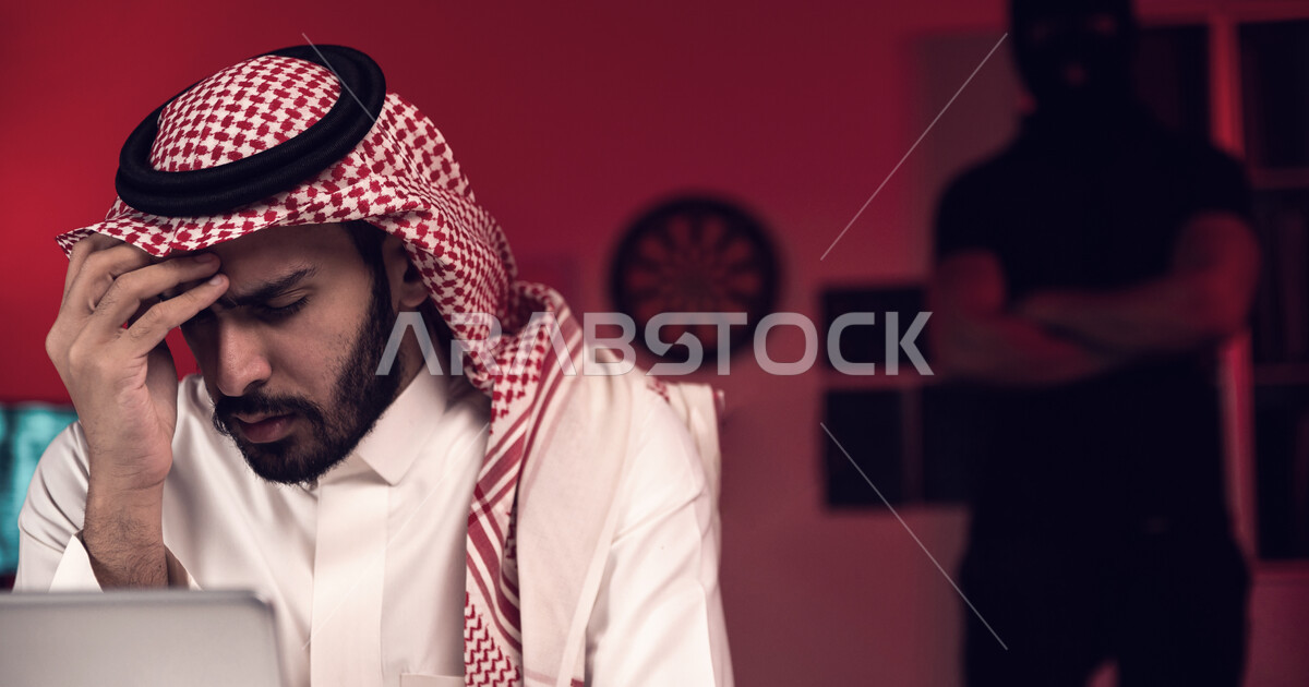 A Saudi Arabian Gulf man sitting in front of the laptop, hacker men ...