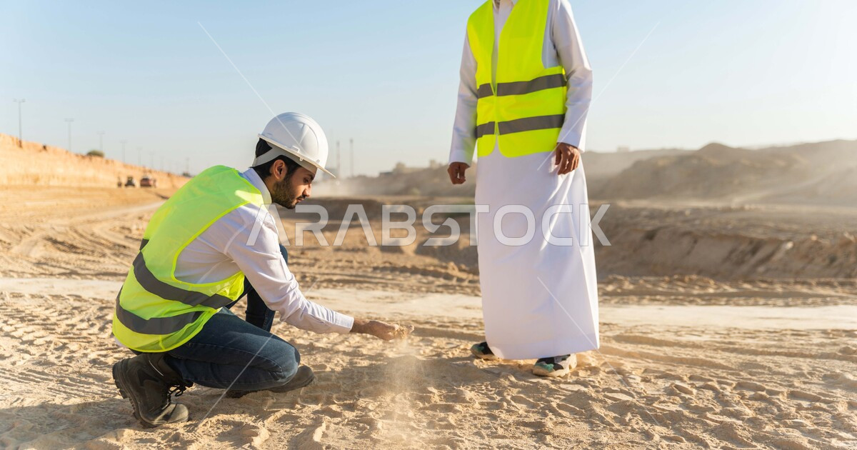 A contractor and a work supervisor wearing a work helmet and jacket ...