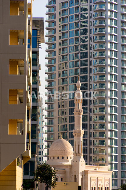 Islamic religious landmarks, a mosque minaret amidst skyscrapers in the ...