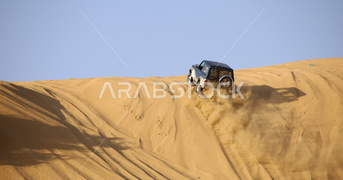 Riding a car on sand dunes and hills, going on adventures using a four ...