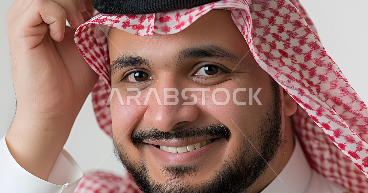 Caring about appearance, portrait of an Arab Gulf Emirati man wearing ...