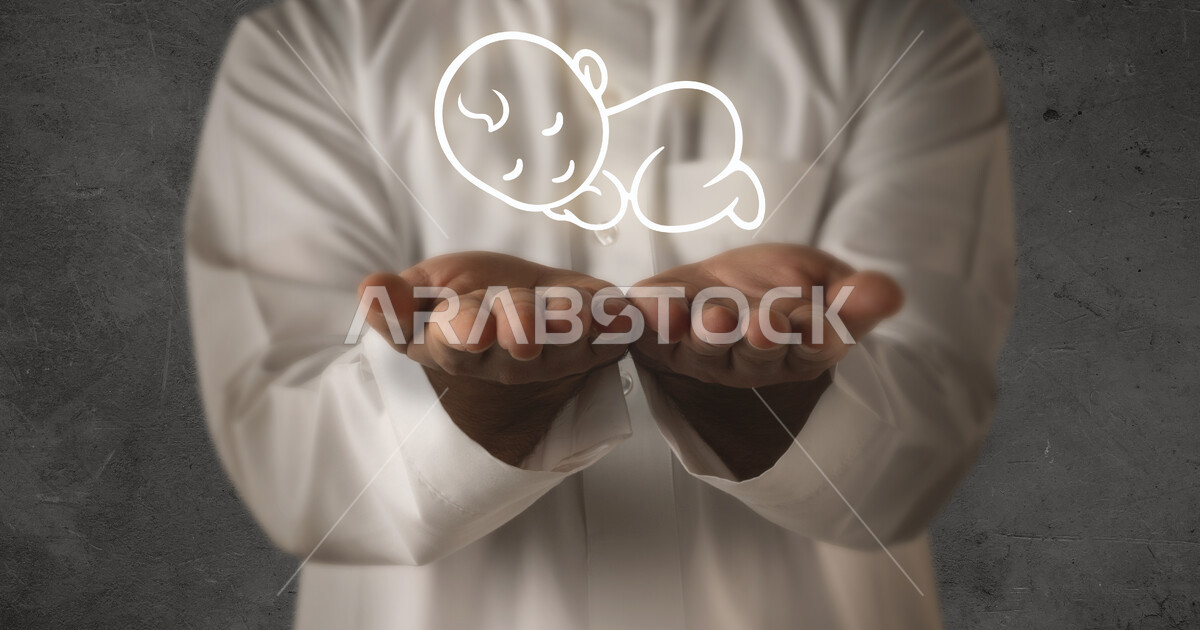 صورة مقربة ليد رجل عربي خليجي سعودي ، يحمل بين يديه بيبي صغير بتقنية ...