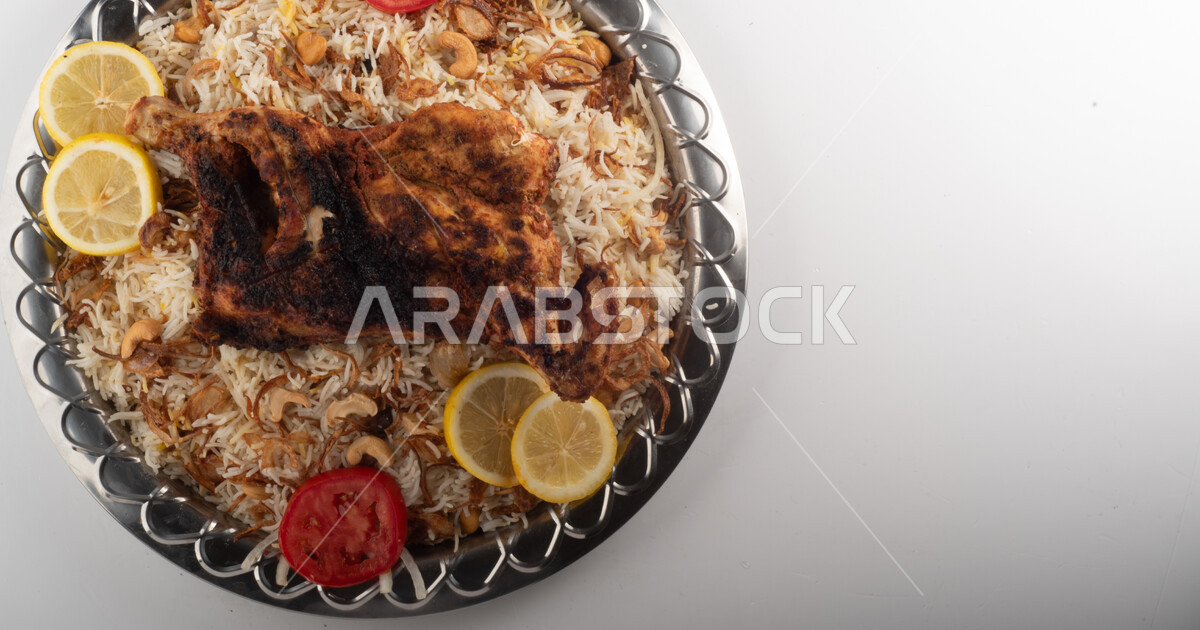 Popular rice dish with Madhbi chicken prepared in Saudi kitchen, brown ...