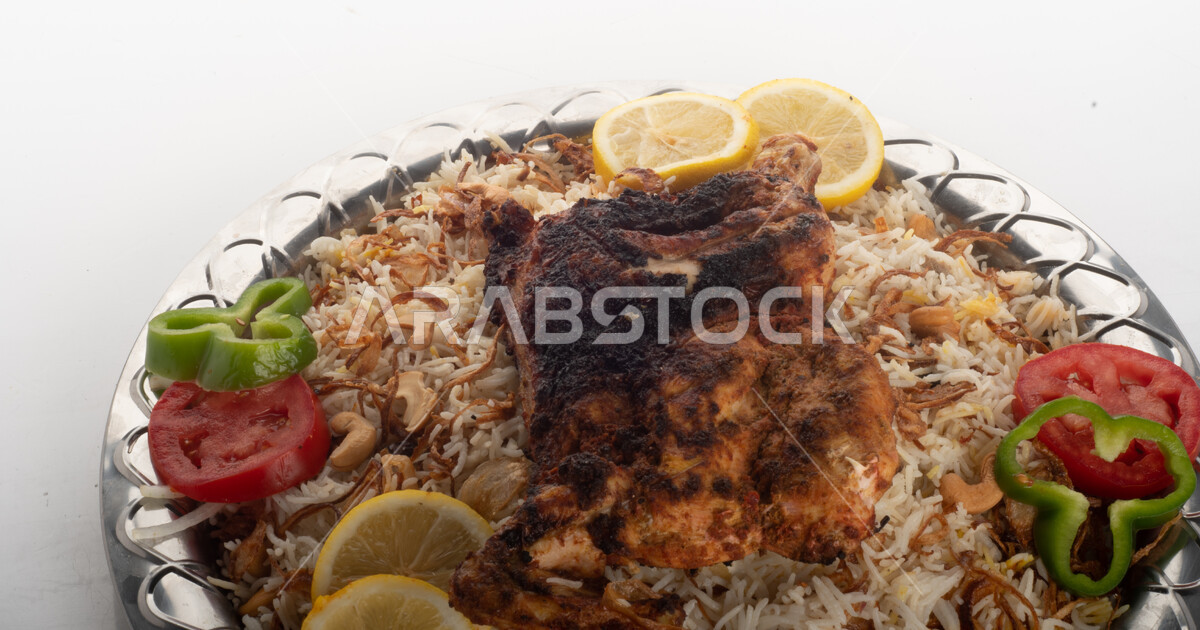 Popular rice dish with Madhbi chicken prepared in Saudi kitchen, brown ...