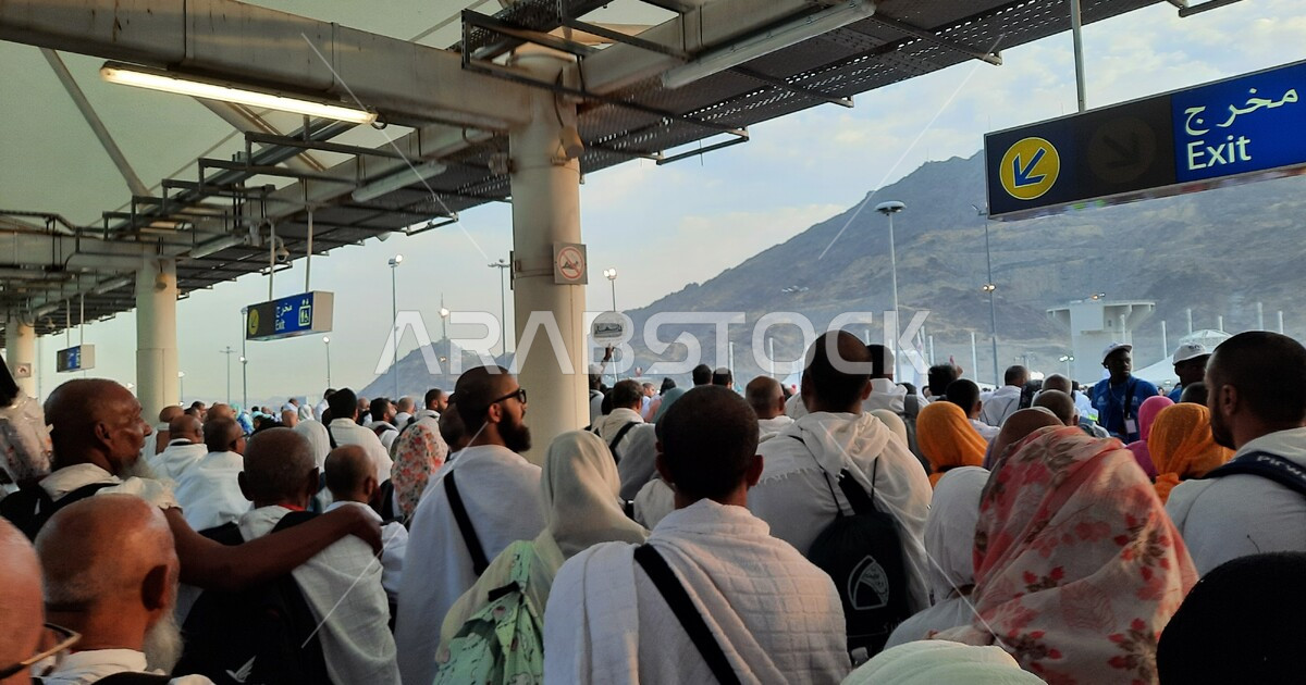 A picture of pilgrims wearing white ihram clothes, moving on the ...