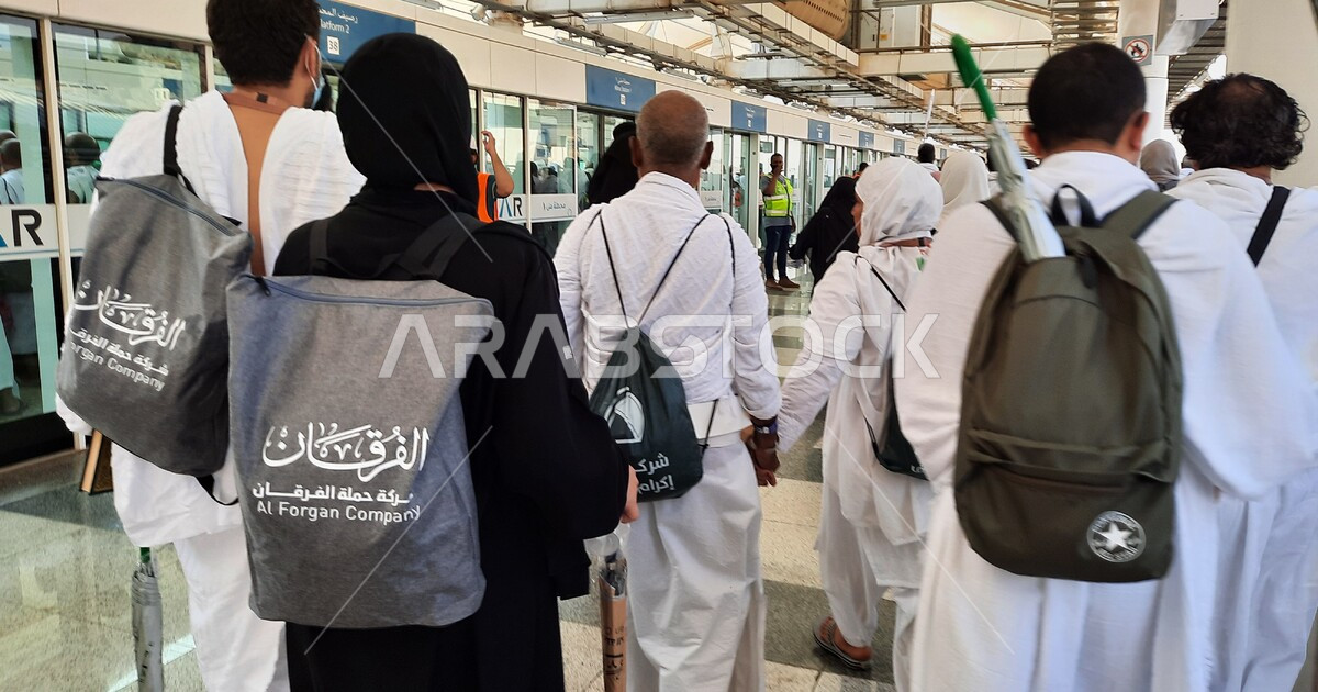 A picture of pilgrims wearing white ihram clothes, moving on the ...