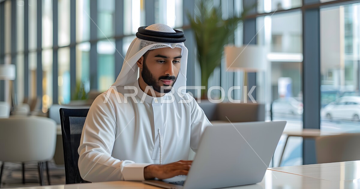 Using modern devices to accomplish tasks, a Saudi Arabian Gulf man ...