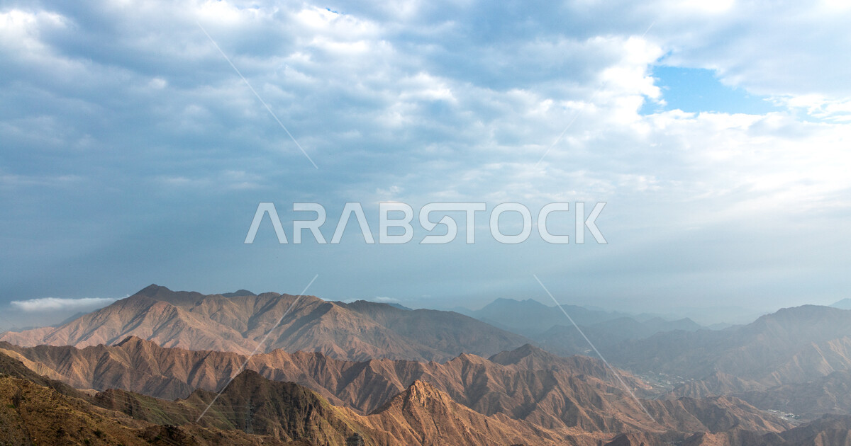 View of the foggy sky filled with clouds over the Al-Soudah Mountains ...