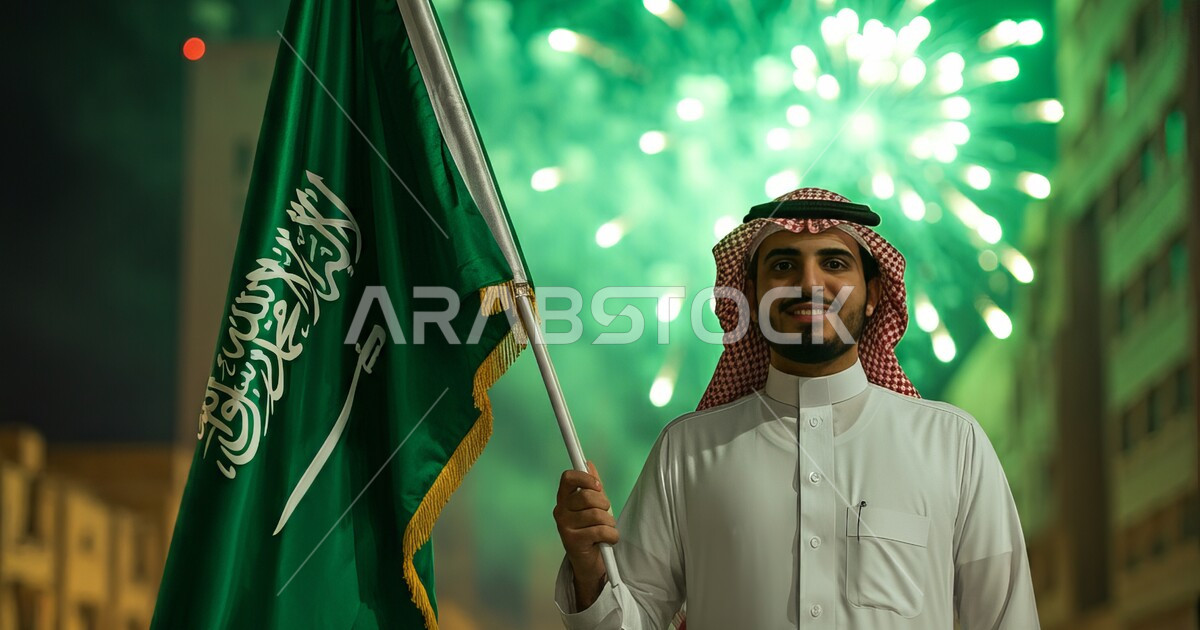 Celebrating the Saudi National Day, a Gulf Saudi holding the flag of ...