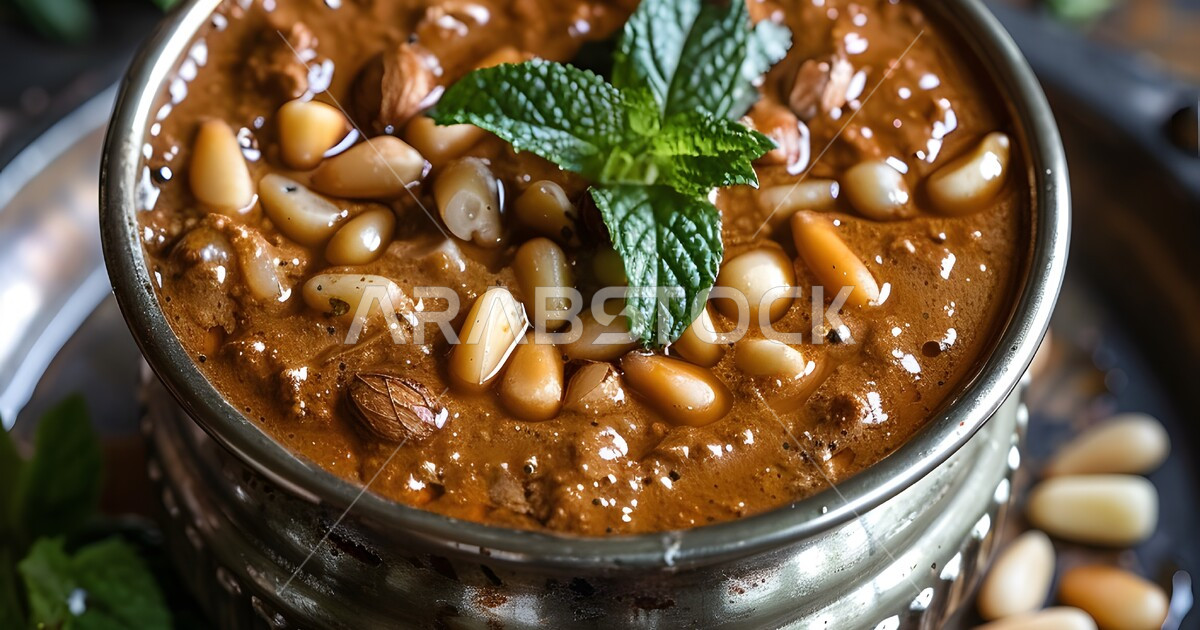 A plate of white bean soup with meat decorated with green leaves, the ...
