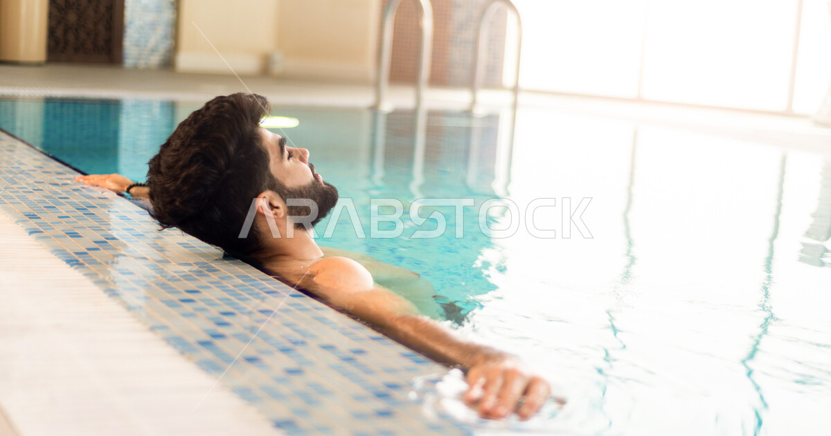 A young Arab from the Saudi, the fun of swimming, training in swimming ...