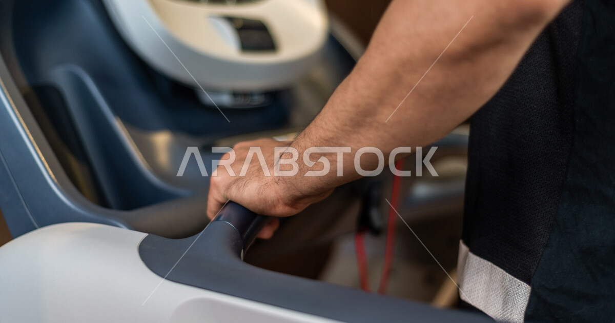 Saudi Arab guy, wearing sports clothes, working out and warming up on ...