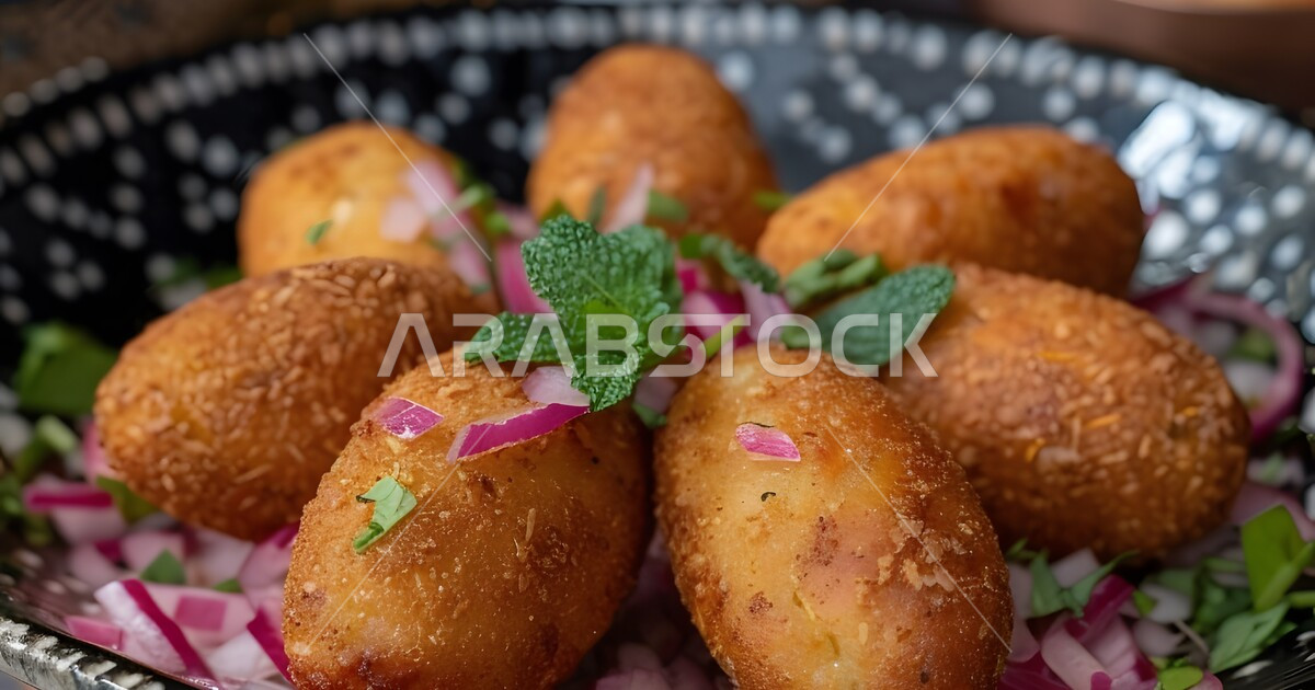Crispy fried potato croquettes with red onions and mint, a meal with ...