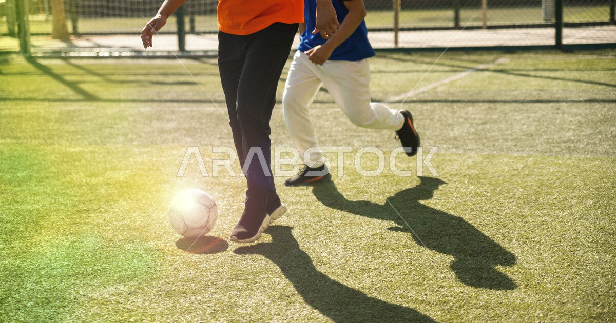A young Arab Saudi Arabian Gulf, football player, practice football ...