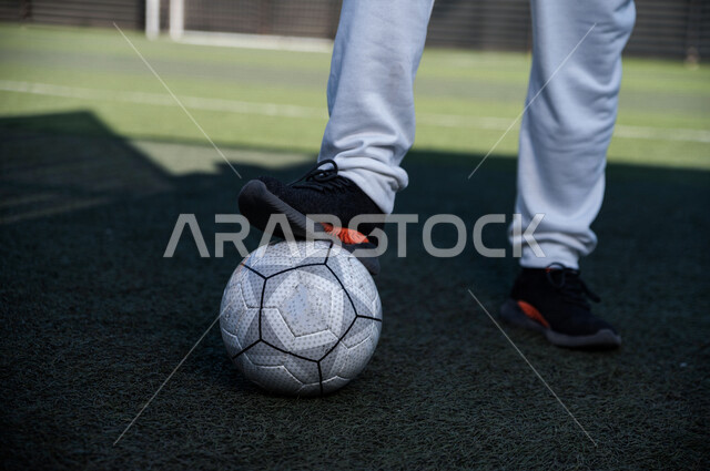 A young Arab Saudi Arabian Gulf, football player, practice football ...