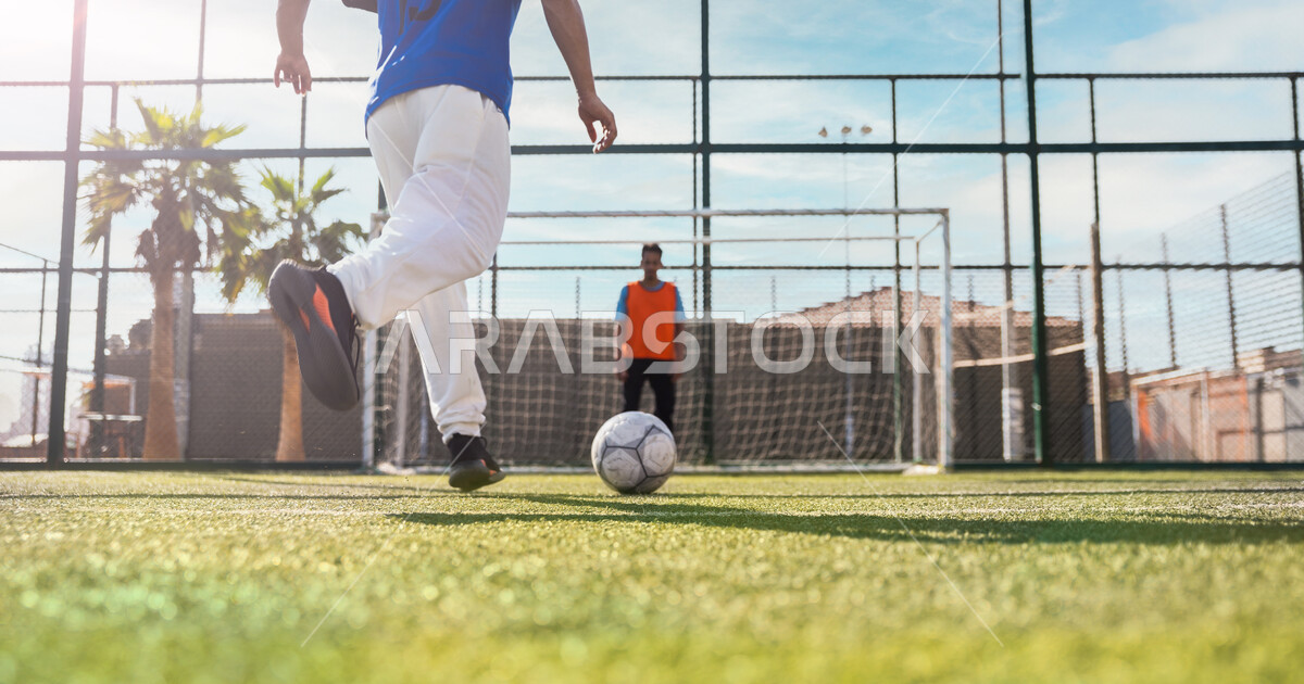 A young Arab Saudi Arabian Gulf, football player, practice football ...