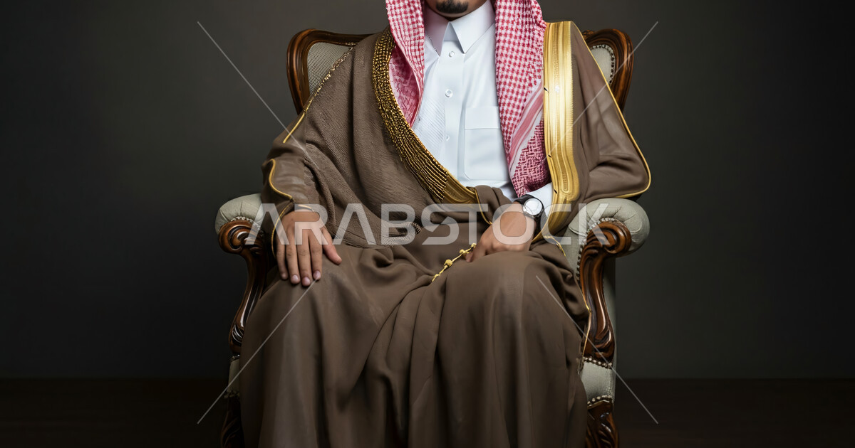 A Saudi Arabian Gulf man wearing traditional folk costume sitting on a ...