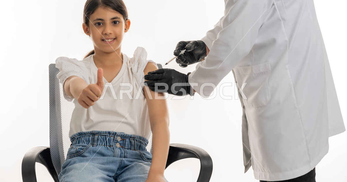 Looking at the camera with gestures of pleasure, an Arab Gulf Emirati ...