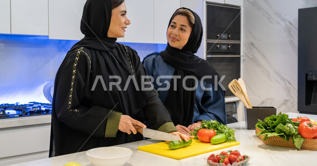 Preparing recipes and delicious food, two Arab Gulf Emirati women ...