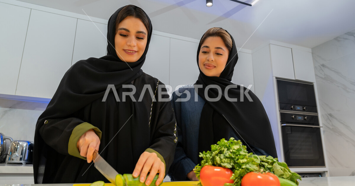 Preparing recipes and delicious food, two Arab Gulf Emirati women ...