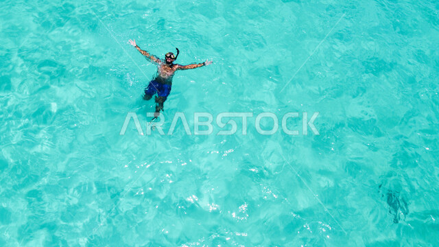 A picture of a young Saudi Arabian Gulf man swimming on Bayada Island ...