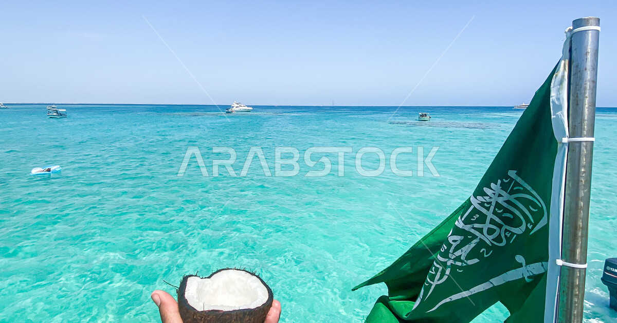 A picture of the hand of a Saudi young man holding coconuts, Bayada ...