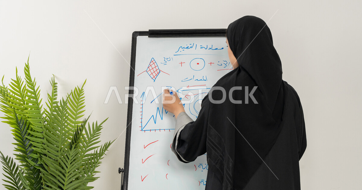 Saudi trainer using blackboard for easy explanation, professional ...