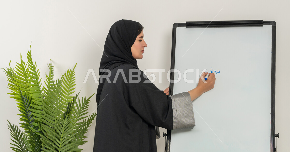 Saudi trainer using blackboard for easy explanation, professional ...