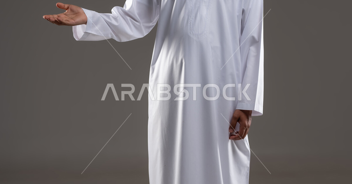 Pointing and directing to a place, portrait of an Arab Gulf Omani man ...