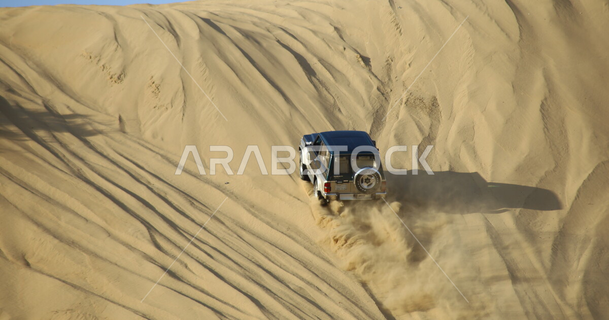 Riding a car on sand dunes and hills, going on adventures using a four ...