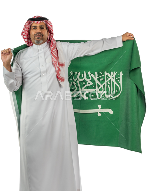 Portrait of a Saudi Arabian Gulf man putting on his back the flag of ...