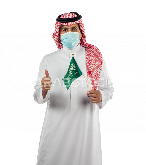 A Saudi Arabian Gulf man wearing a traditional Gulf dress, holding the ...