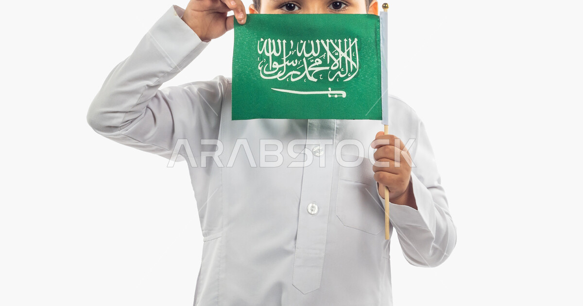 Portrait of a Saudi Arabian Gulf child with the flag of the Kingdom of ...